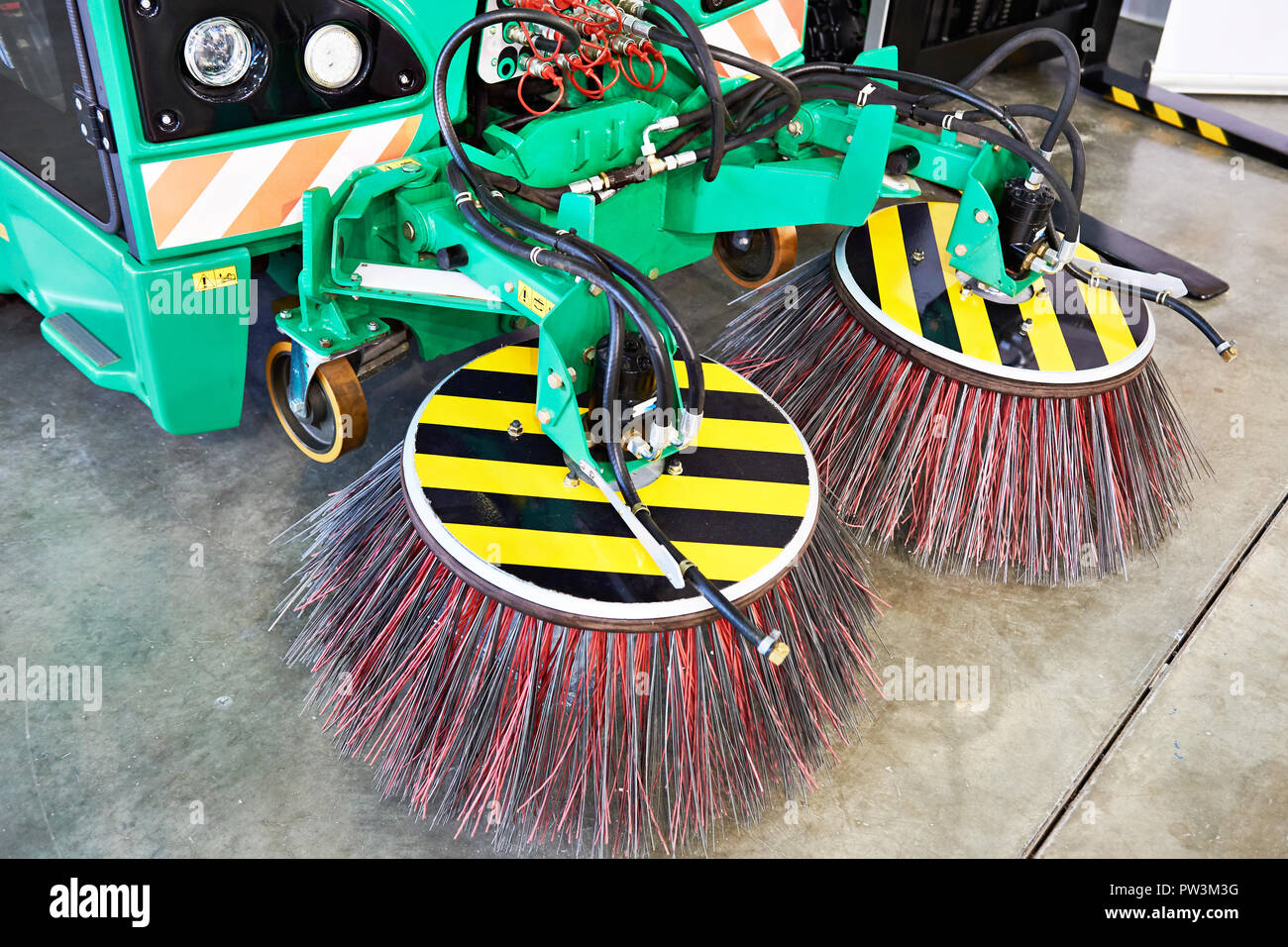 Round brushes for small street cleaning machine Stock Photo - Alamy