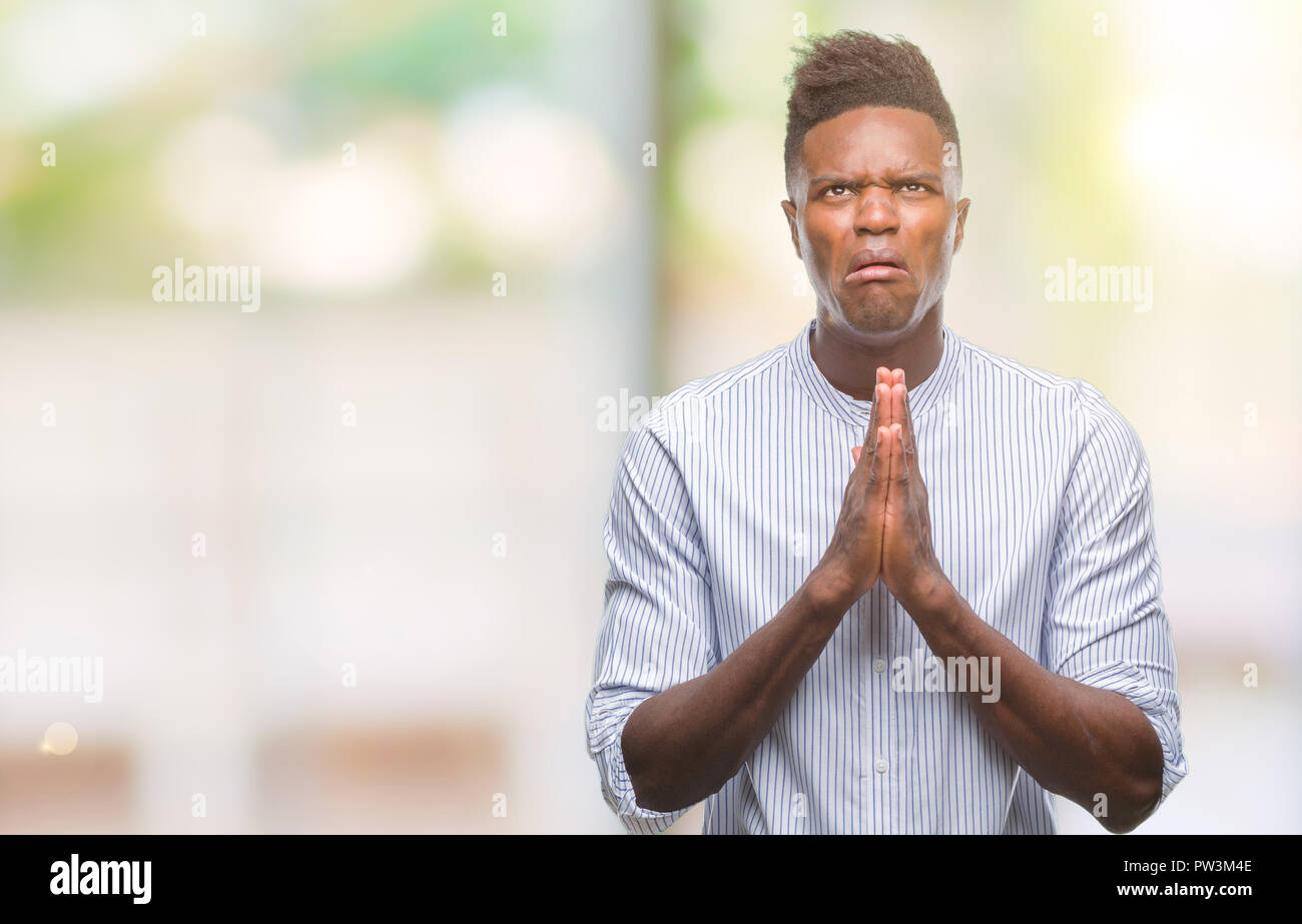Young african american man over isolated background begging and praying ...