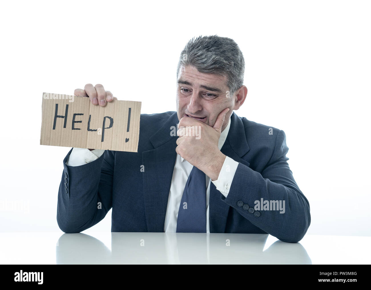 Helpless mature businessman holding a help sign in financial crisis ...