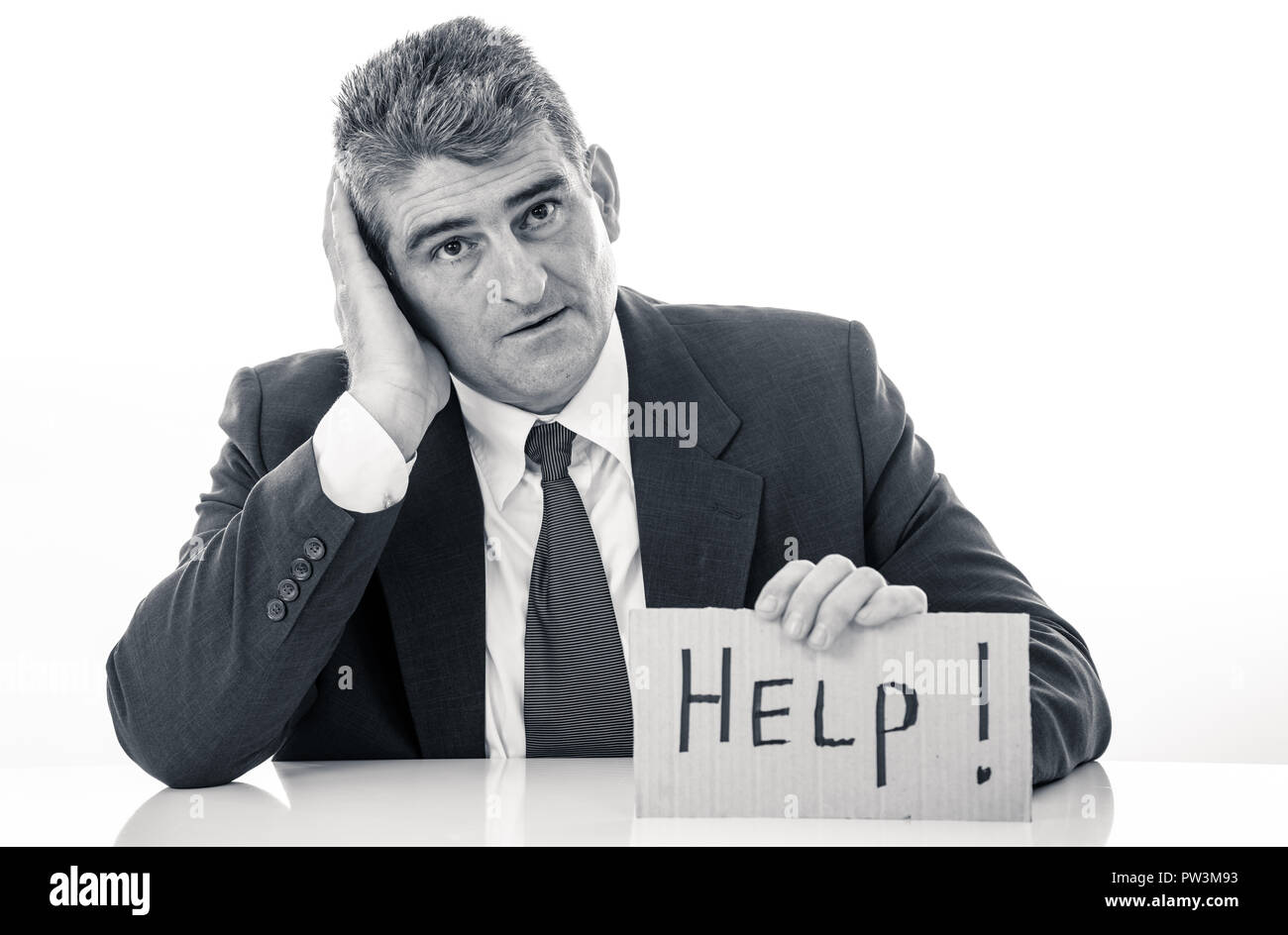 Helpless mature businessman holding a help sign in financial crisis ...