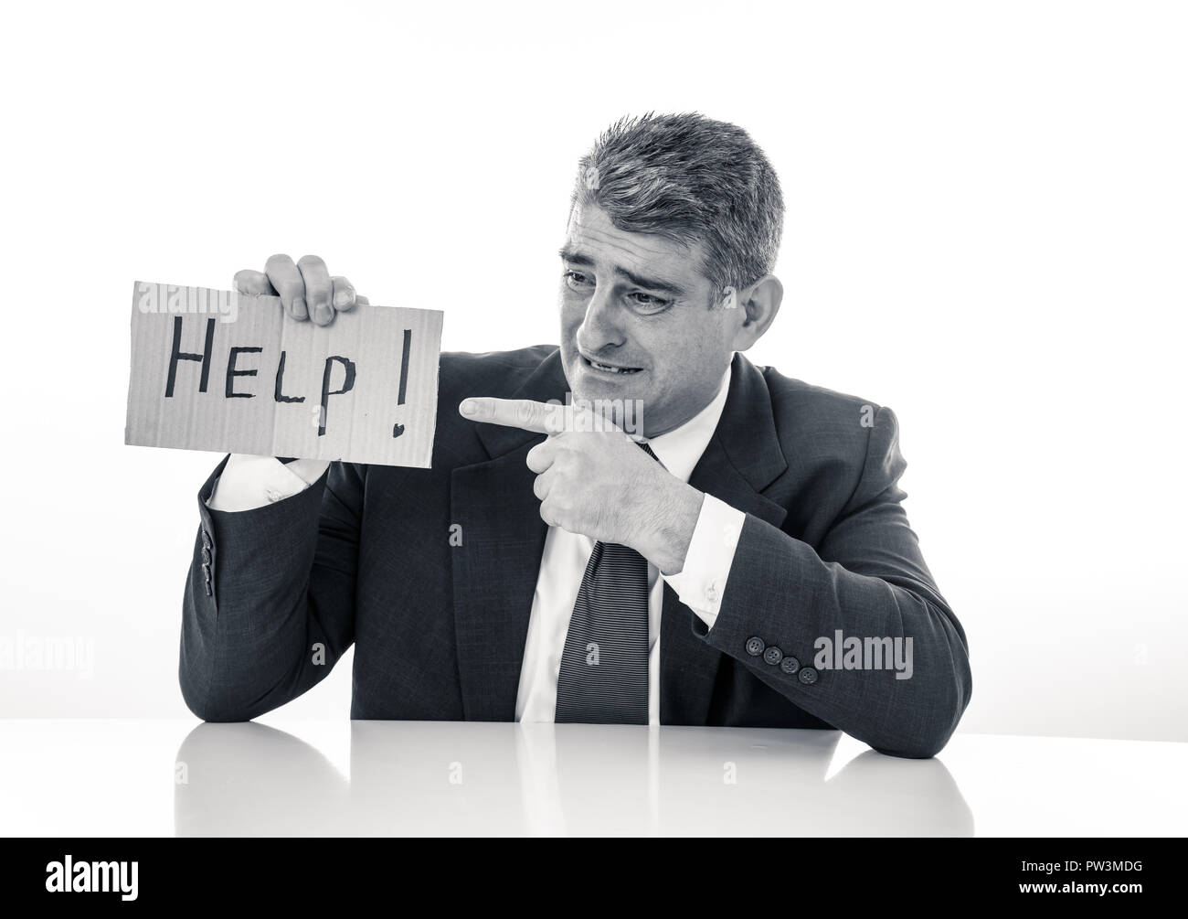 Helpless mature businessman holding a help sign in financial crisis ...