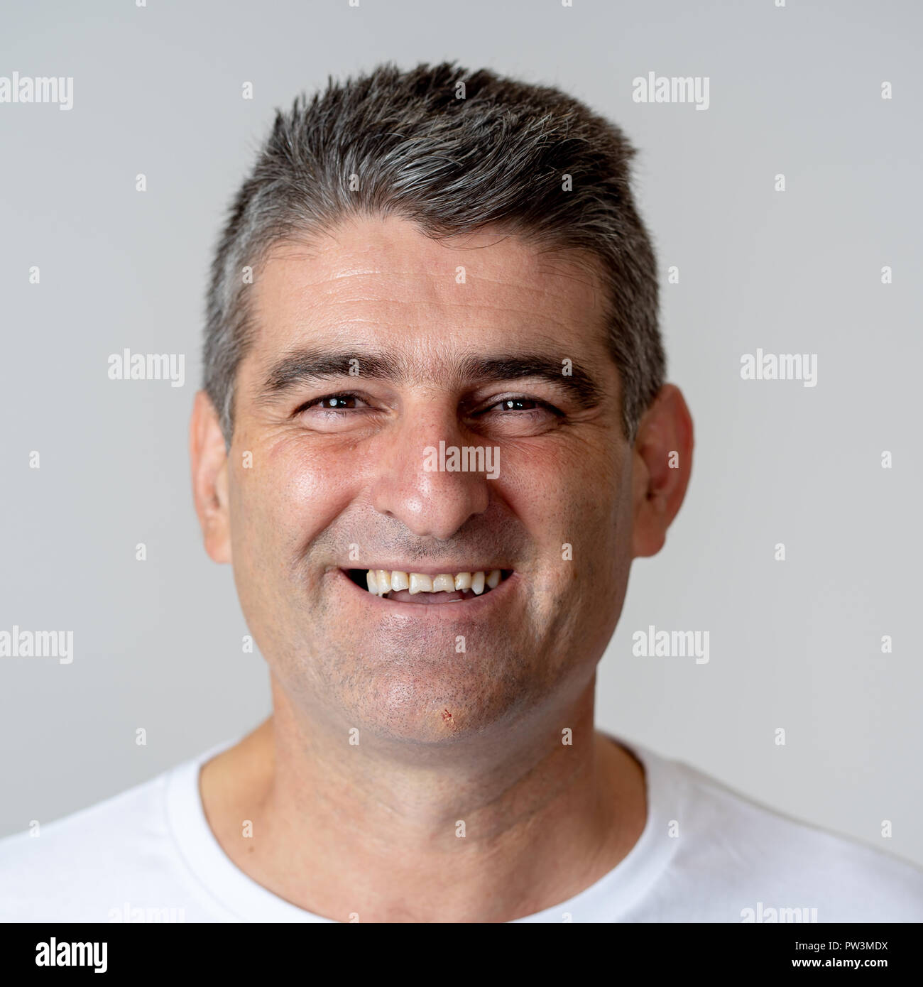 Close up portrait of an attractive middle aged man having fun and ...