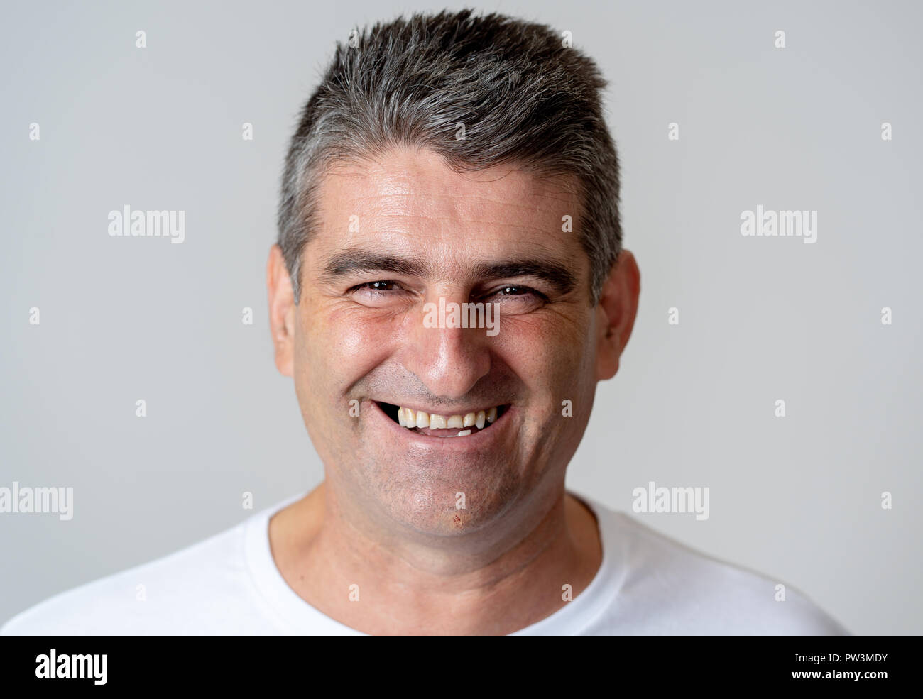 Close up portrait of an attractive middle aged man having fun and ...