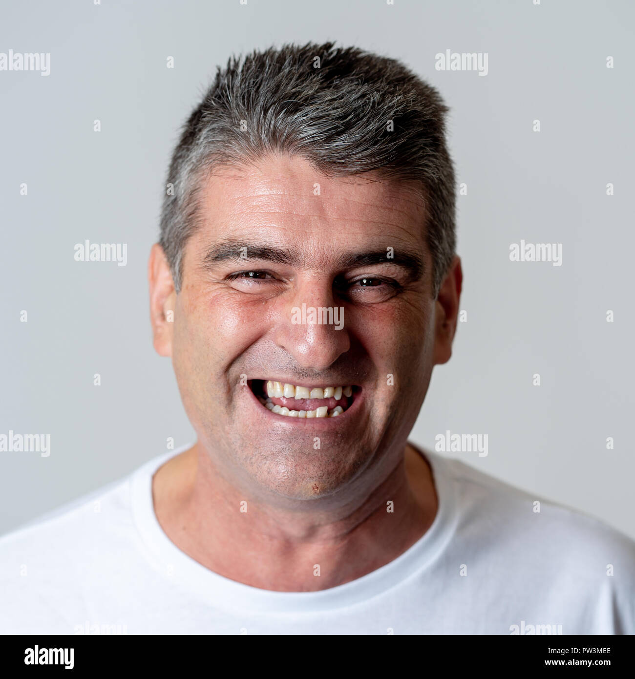 Close up portrait of an attractive middle aged man having fun and ...