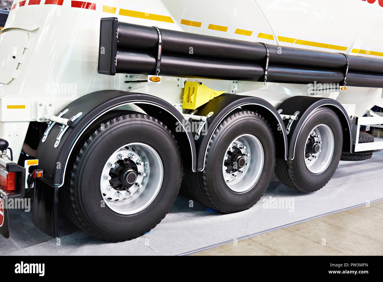 Three wheels semi-trailer with a tank Stock Photo - Alamy
