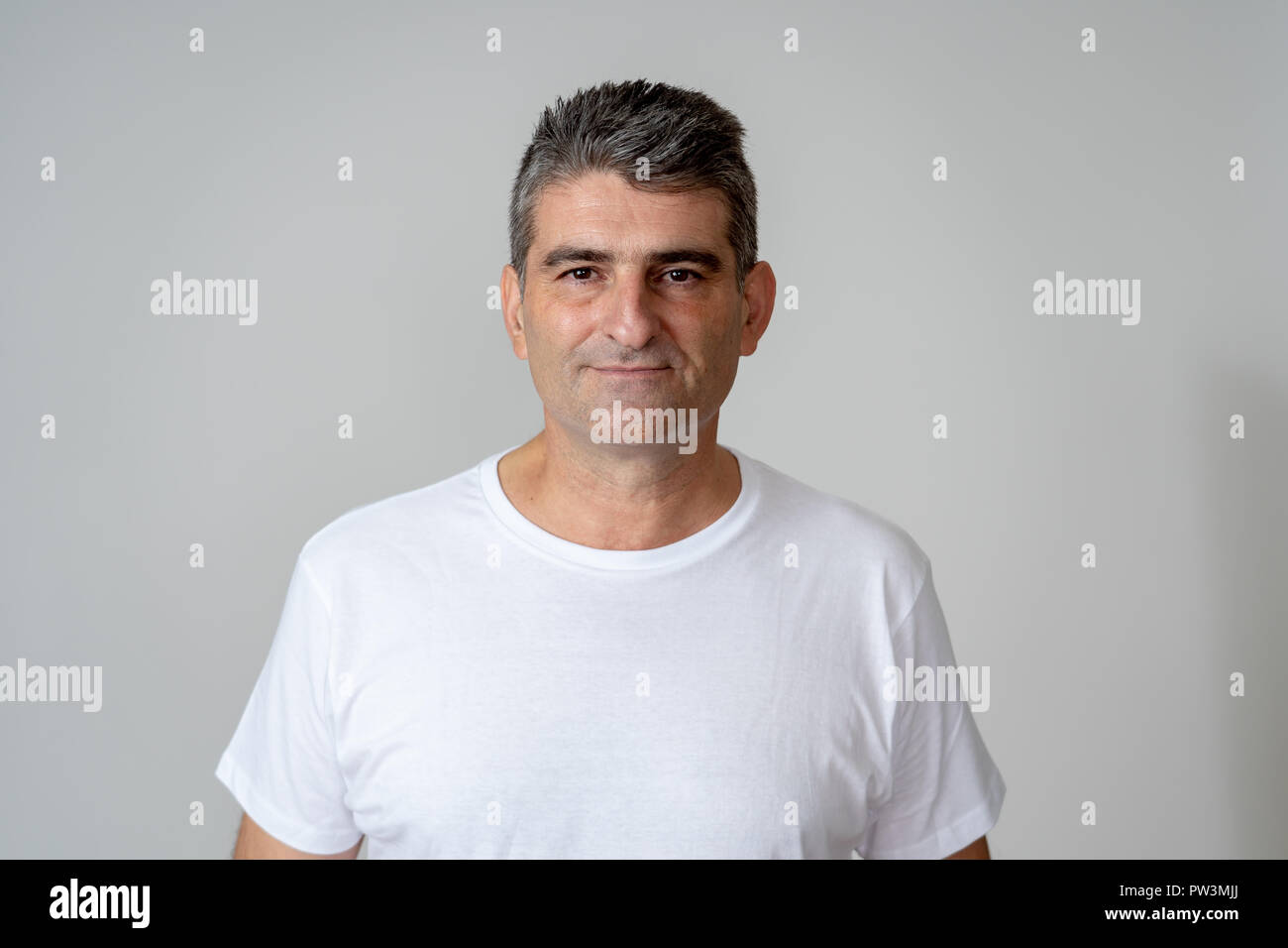 Portrait of a attractive mature man looking neutral relaxed and serious ...
