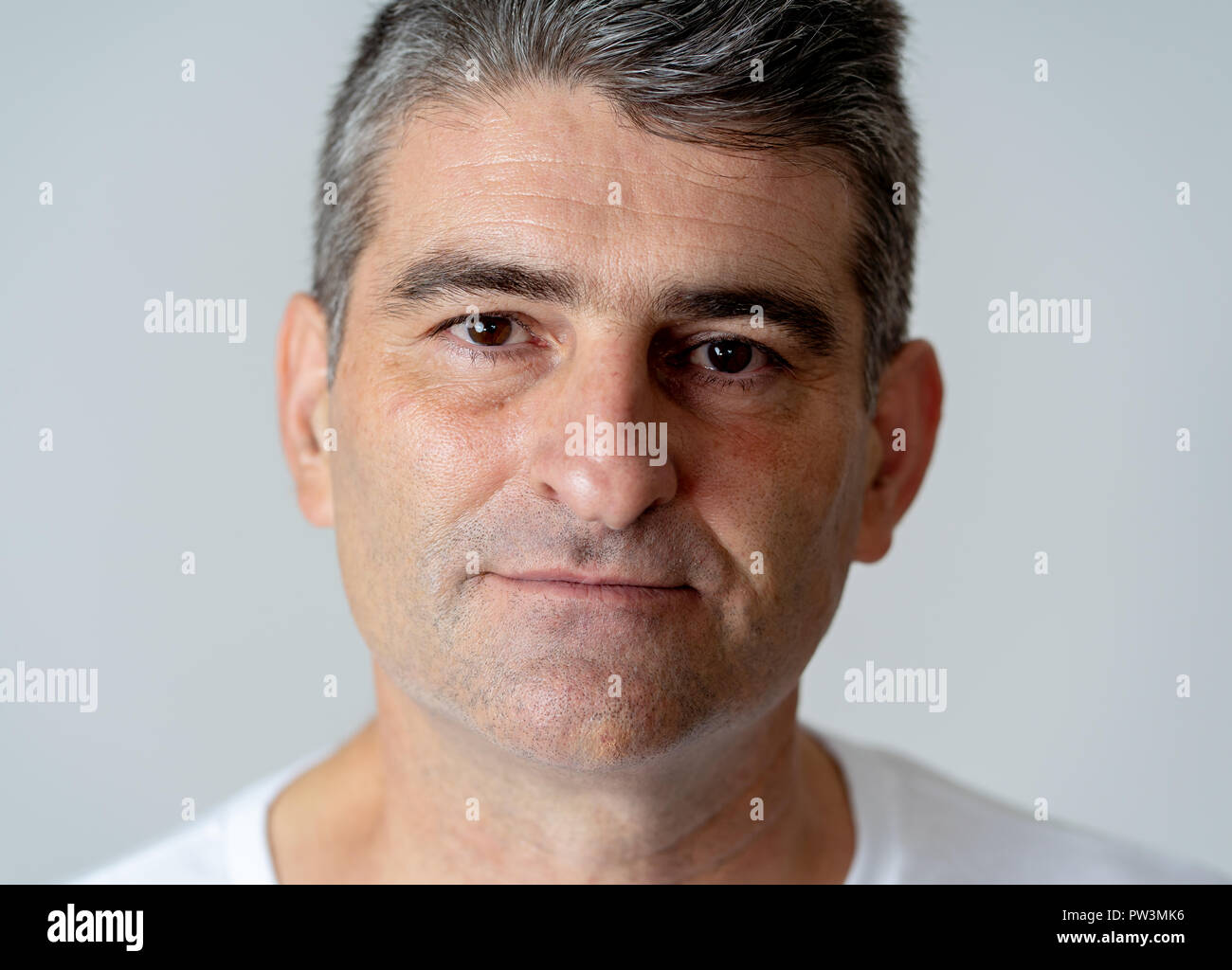 Portrait of a attractive mature man looking neutral relaxed and serious ...