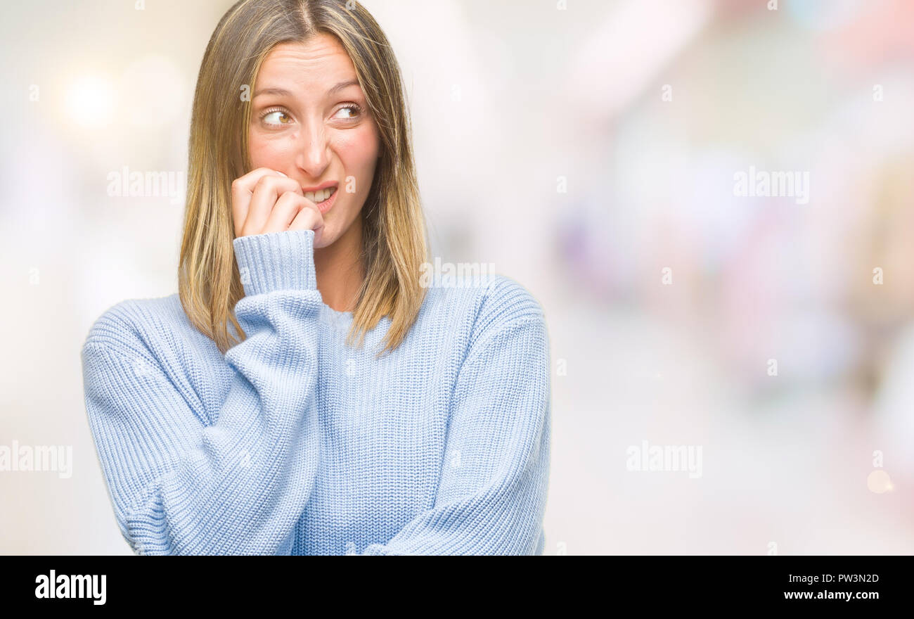 Young beautiful woman wearing winter sweater over isolated background ...