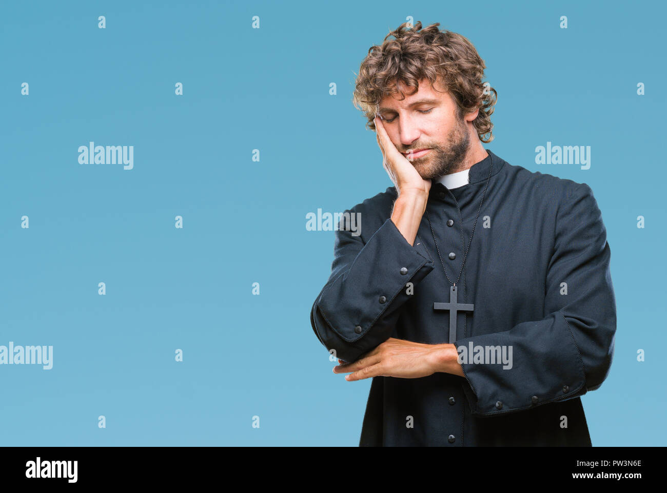 Handsome hispanic catholic priest man over isolated background thinking ...