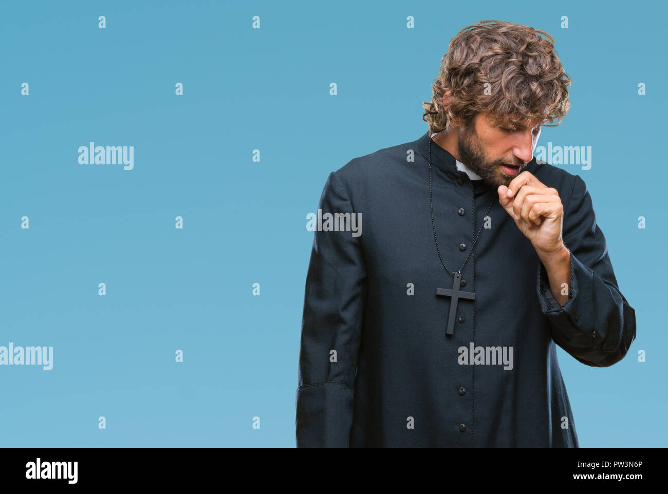 Handsome hispanic catholic priest man over isolated background feeling ...