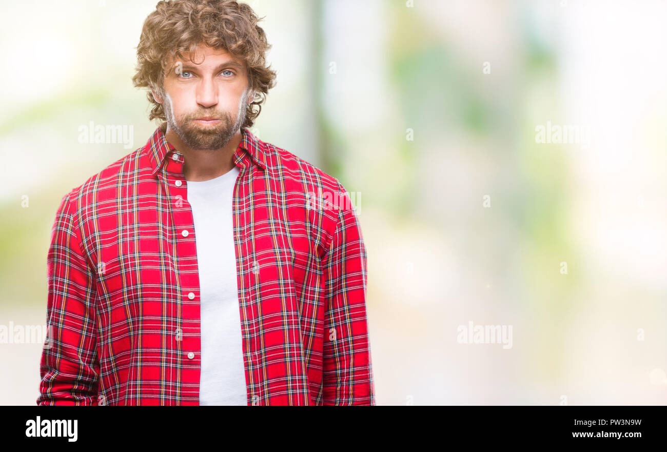 Handsome hispanic model man over isolated background puffing cheeks ...
