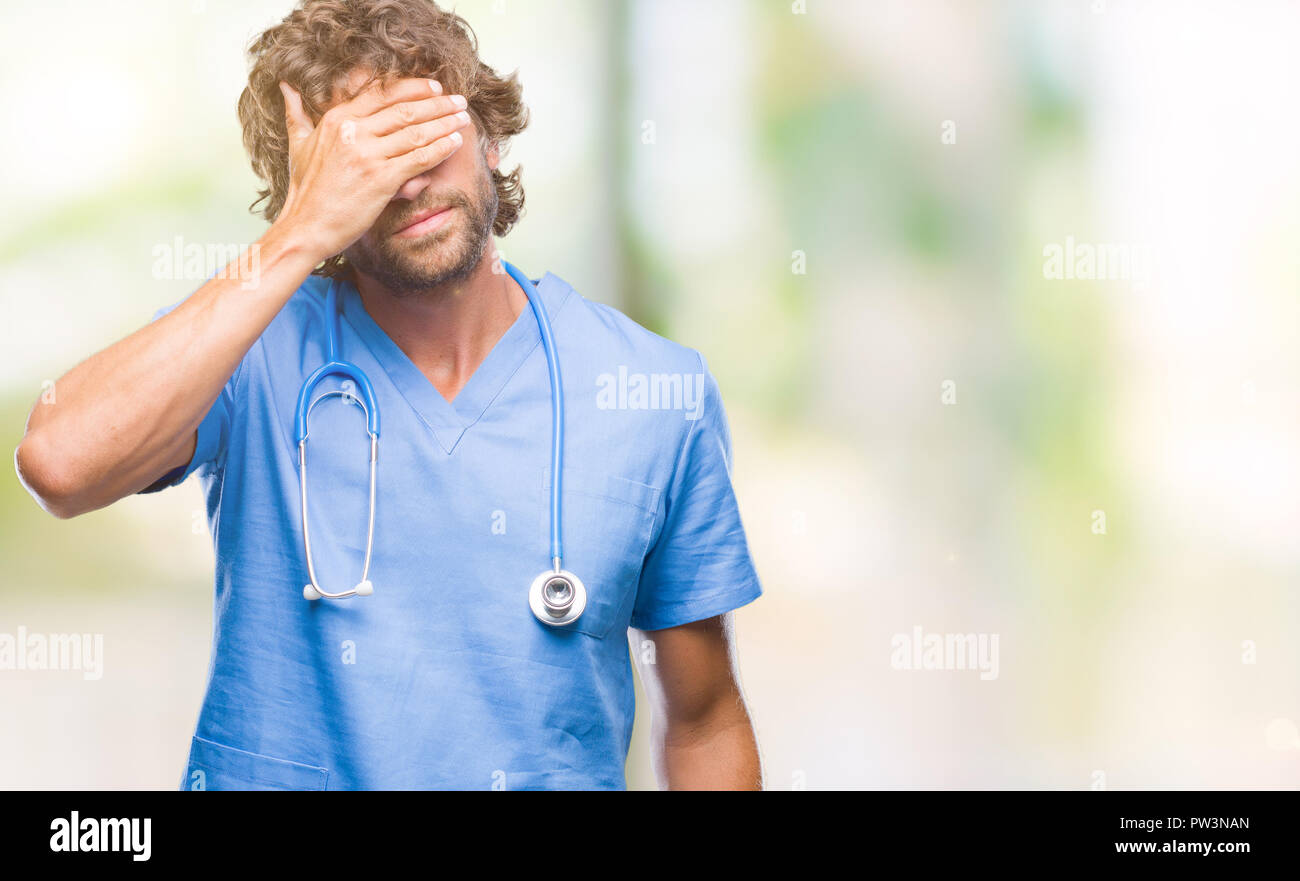 Handsome hispanic surgeon doctor man over isolated background smiling ...