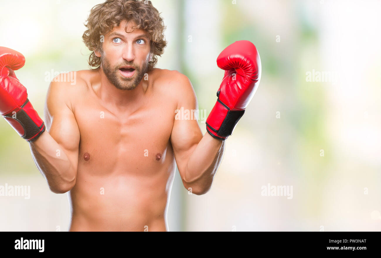 Handsome hispanic boxer man wearing boxing gloves over isolated ...