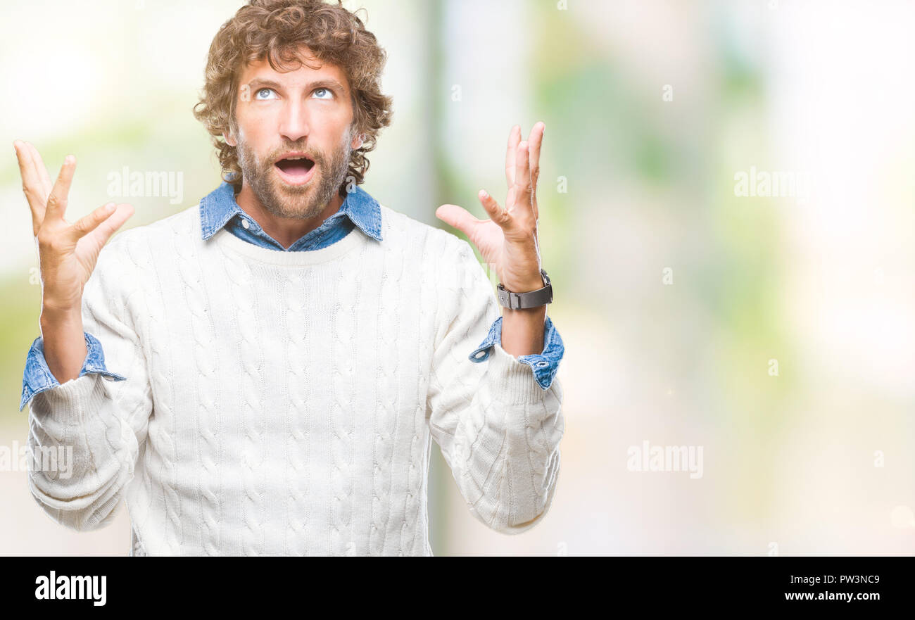 Handsome hispanic man model wearing winter sweater over isolated ...