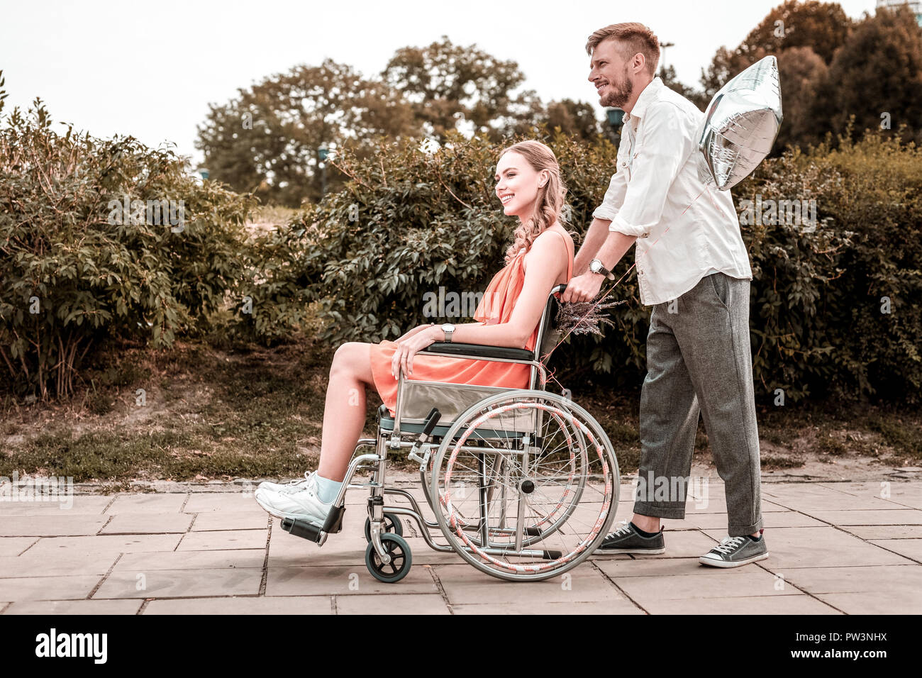 Girl pushing wheelchair hi-res stock photography and images - Alamy