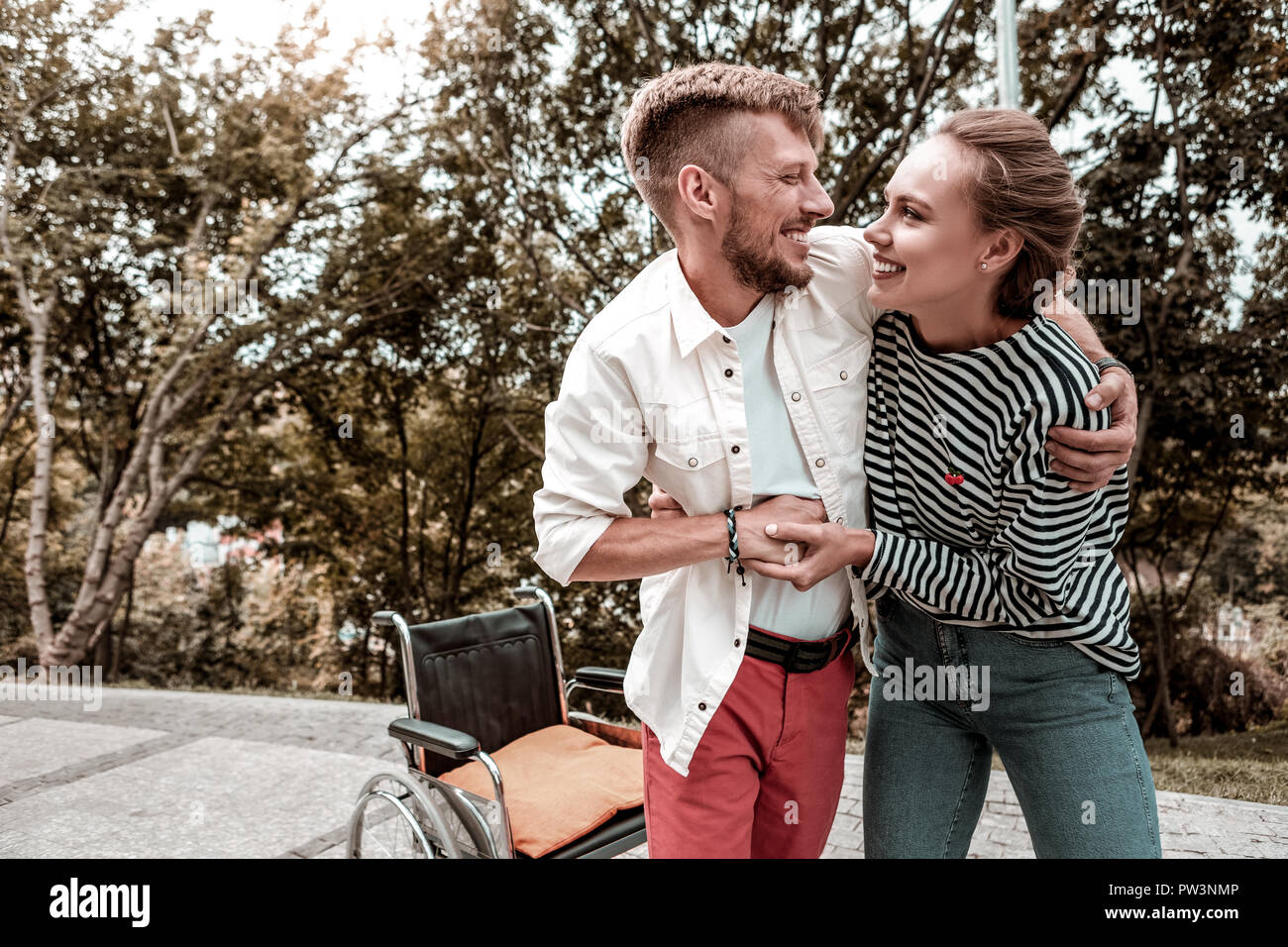 Disabled man smiling while standing up from his wheelchair Stock Photo ...
