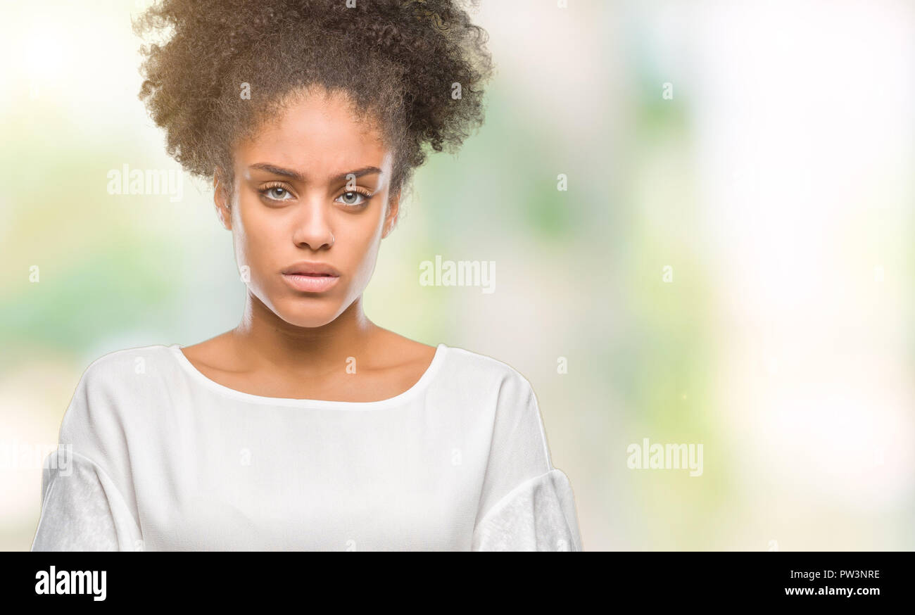 Young afro american woman over isolated background skeptic and nervous ...
