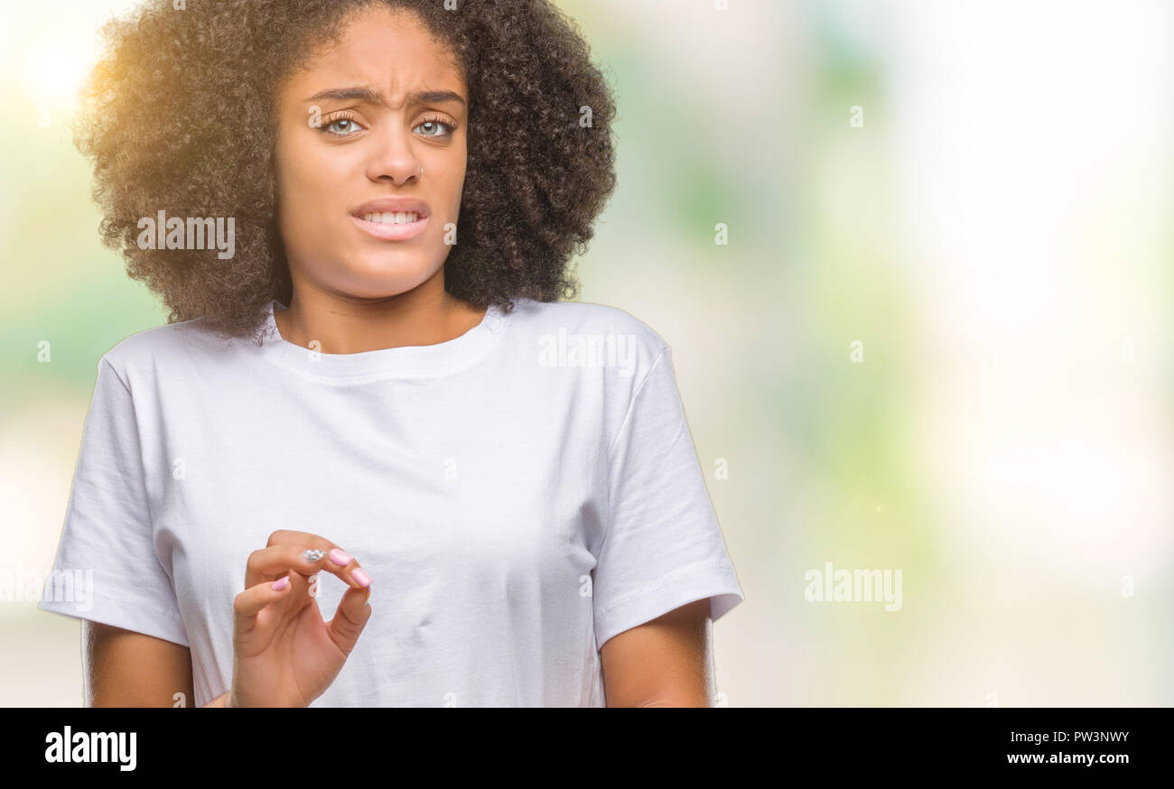 Young afro american woman over isolated background disgusted expression ...