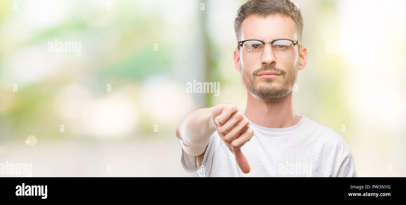 Young tattooed adult man looking unhappy and angry showing rejection ...