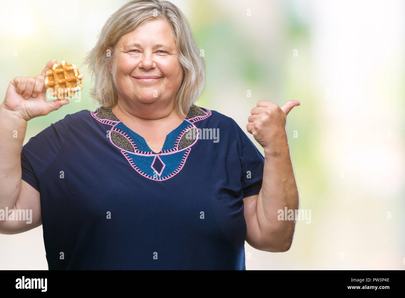 Senior plus size caucasian woman eating waffle over isolated background ...