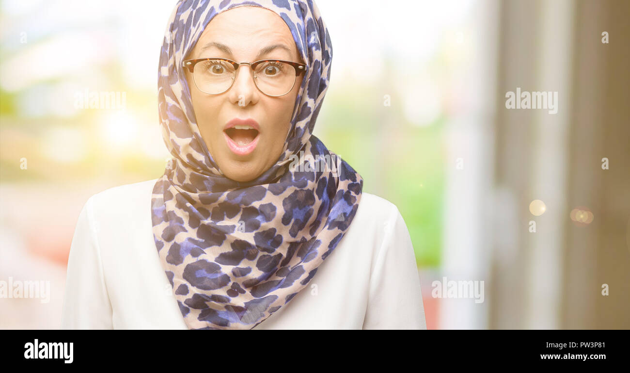 Middle age muslim arab woman wearing hijab scared in shock, expressing ...