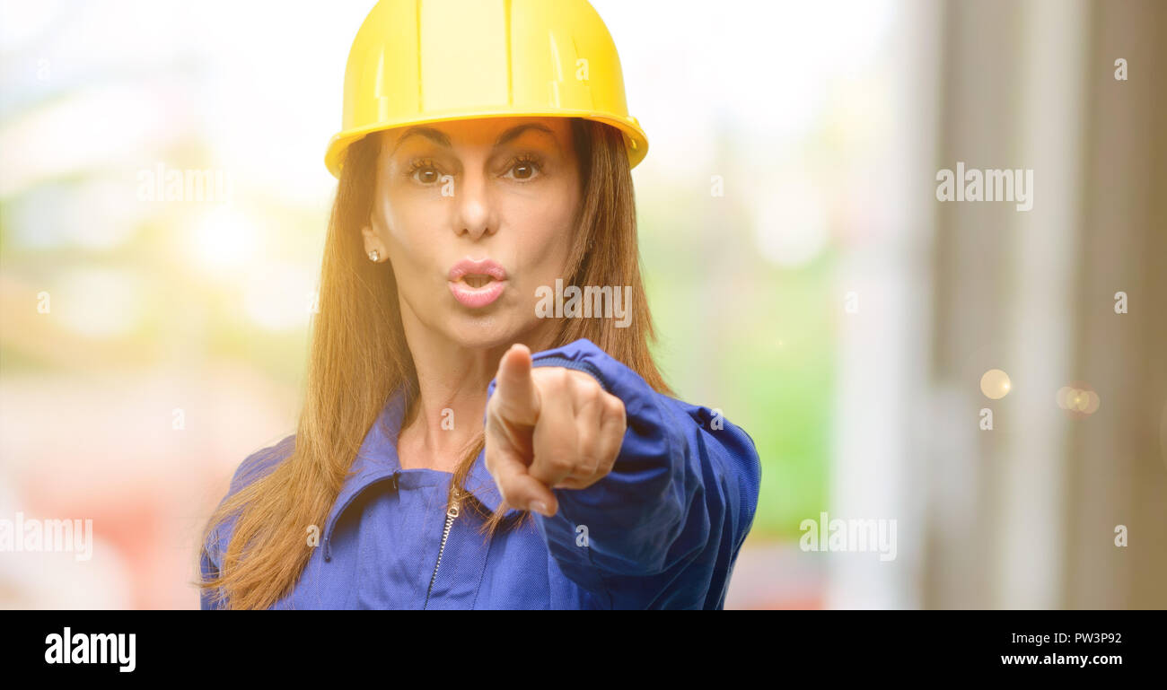 Engineer construction worker woman pointing to the front with finger ...