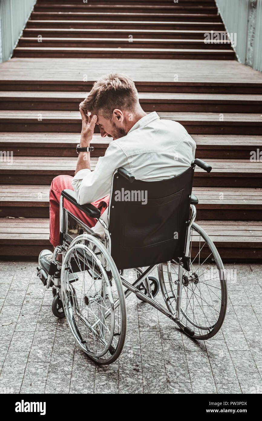Disabled man facing problematic situation with going upstairs Stock ...