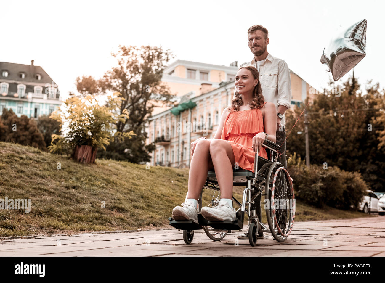 Disabled girl smiling while having pleasant day with her boyfriend ...