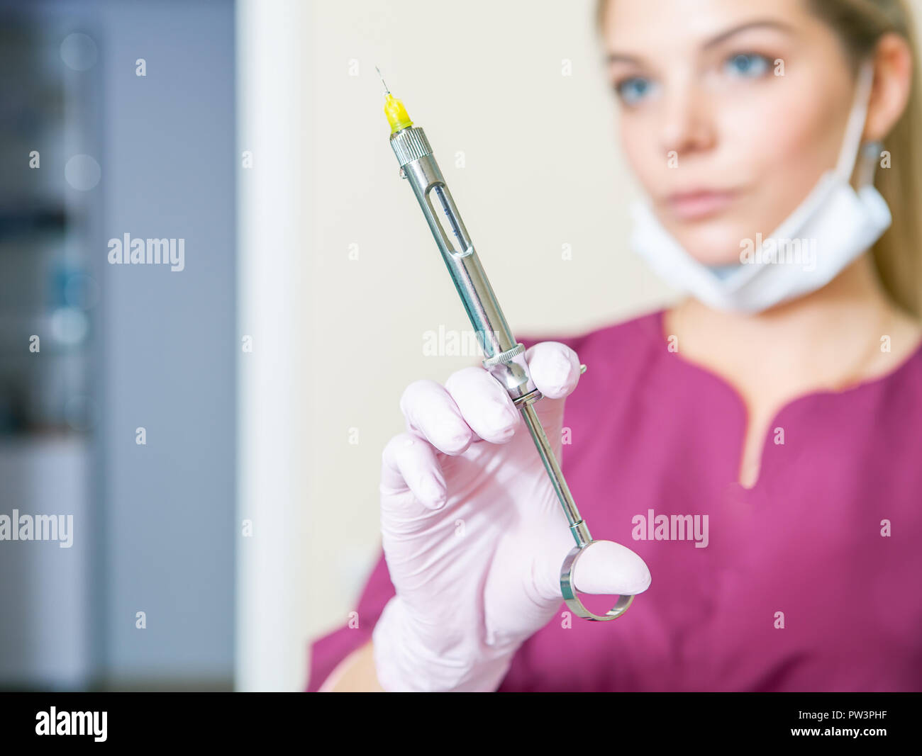 Female dentist in dental office talking with female patient and ...