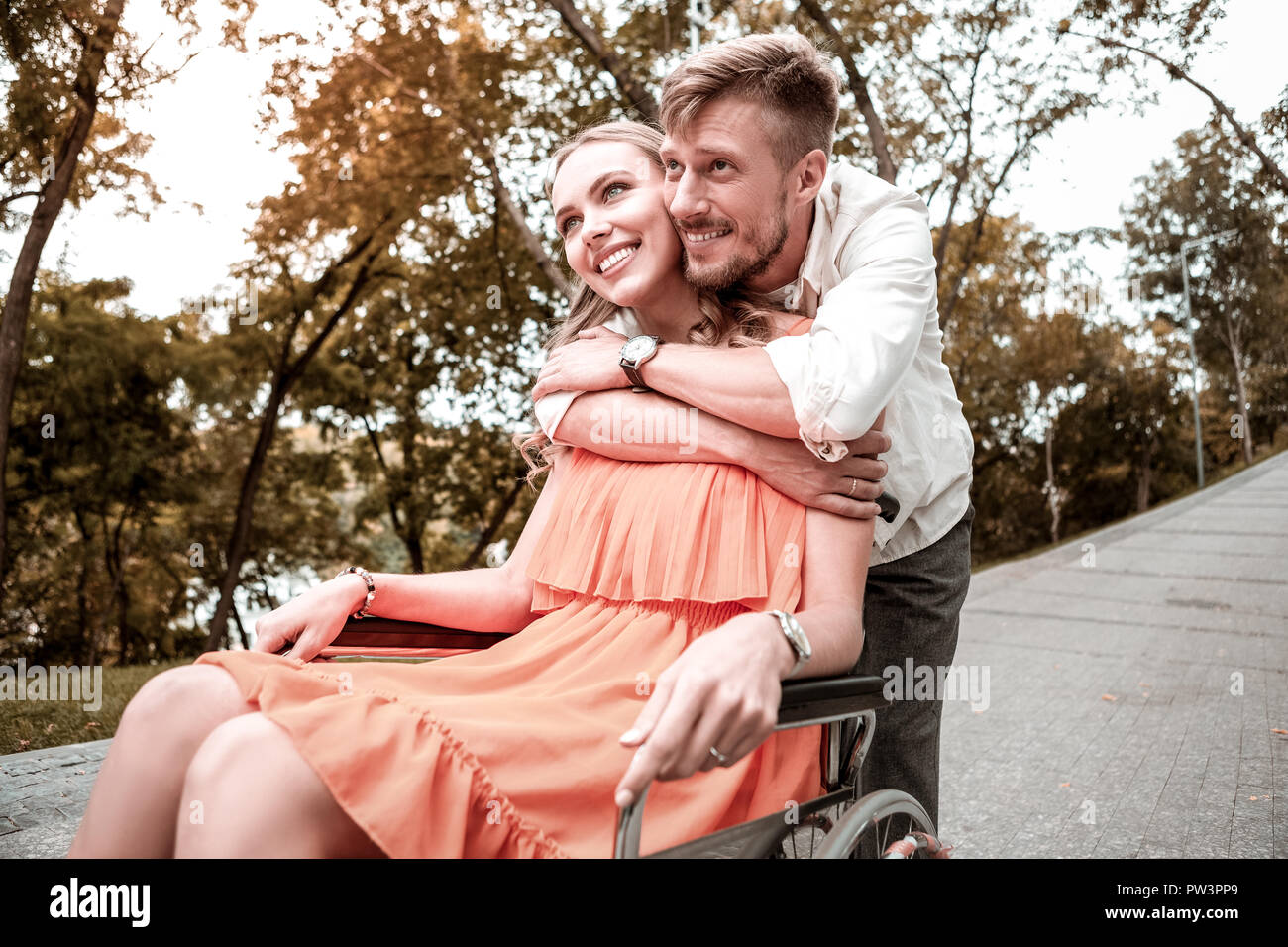 Positive woman hugging disabled hi-res stock photography and images - Alamy