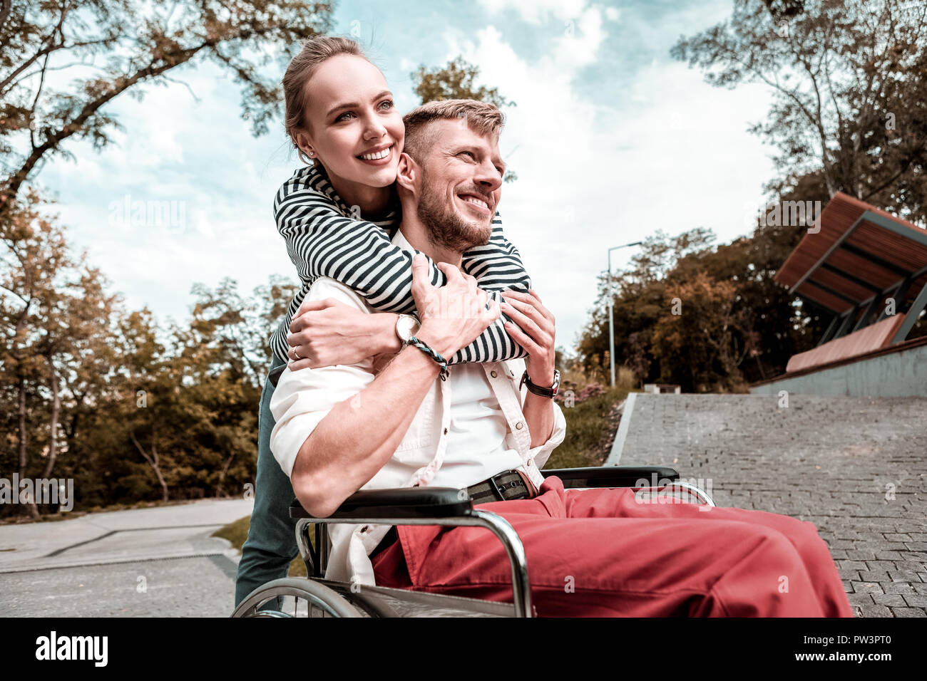 Happy woman hugging disabled hi-res stock photography and images - Alamy