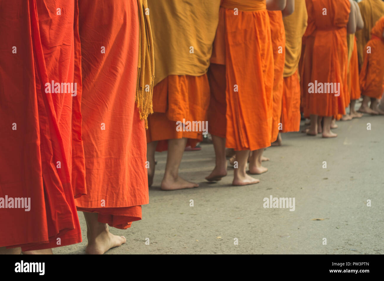 Monks Alms-round or receive food offerings moment. Focus on robe and ...