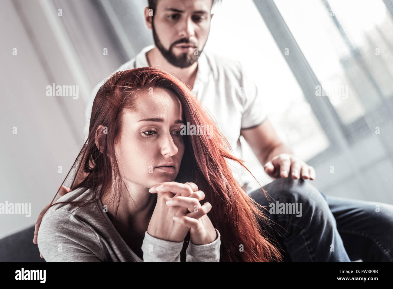 Cheerless unhappy woman holding her hands together Stock Photo - Alamy