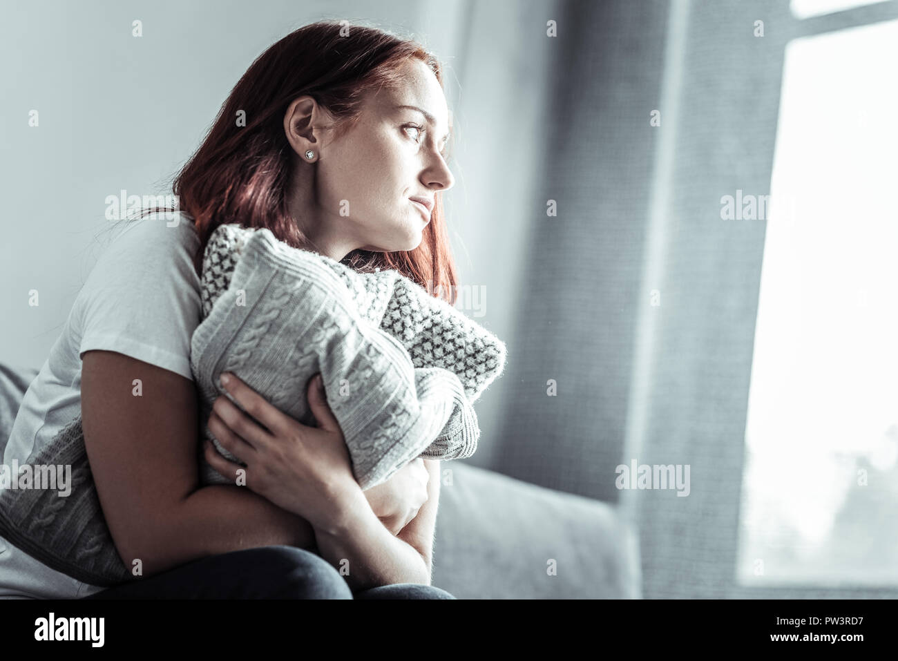 Upset female person looking at the window Stock Photo - Alamy