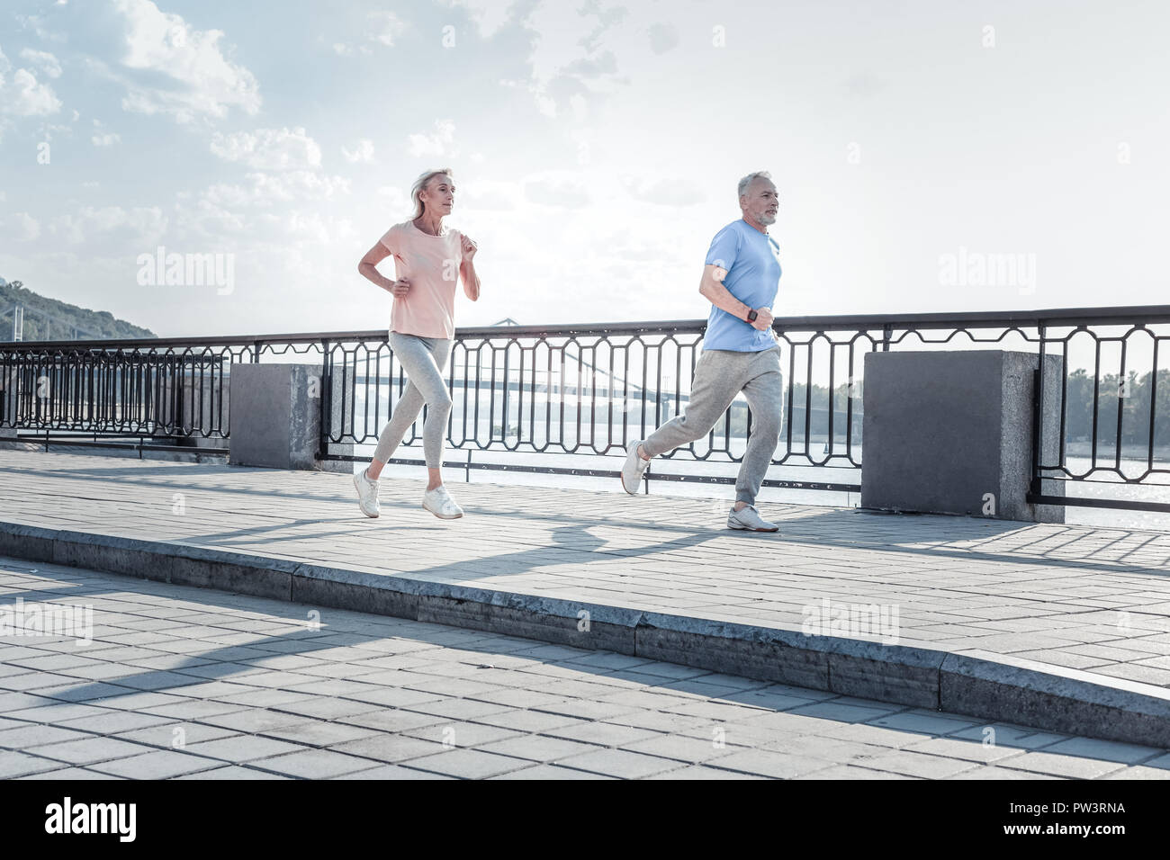Lovely couple going in for running Stock Photo - Alamy