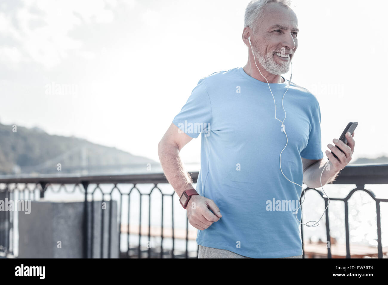 High-spirited male person running with pleasure Stock Photo - Alamy
