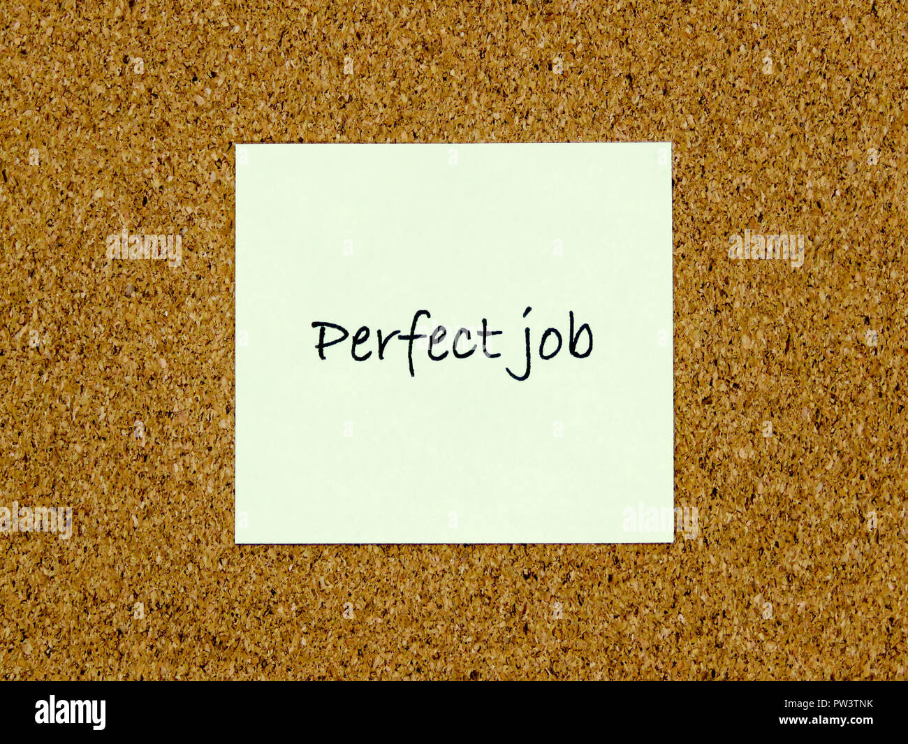 A yellow sticky note with perfect job written on it on a cork board ...