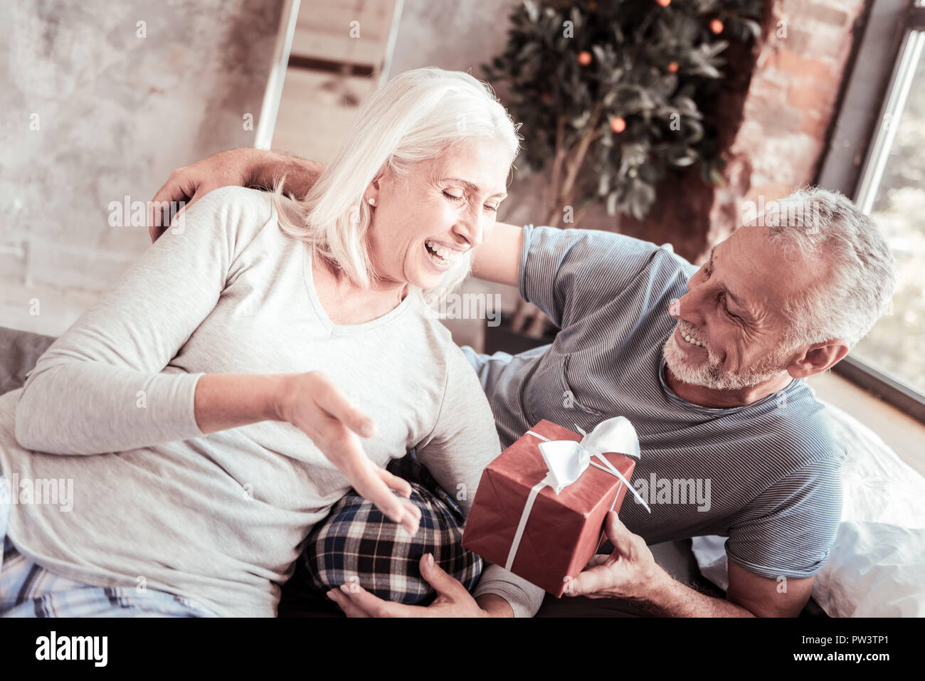 Positive surprise couple present hi-res stock photography and images ...