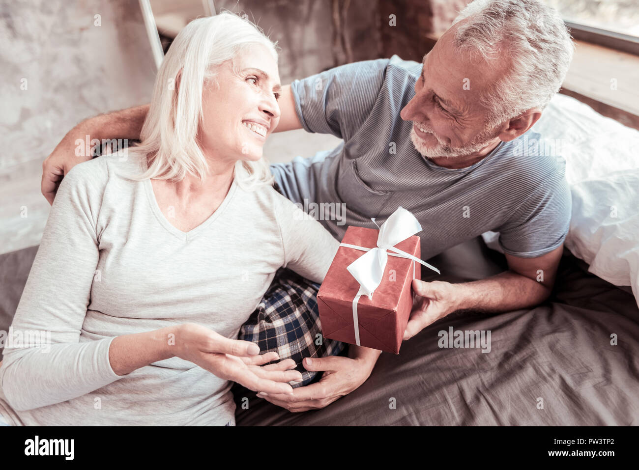 Positive surprise couple present hi-res stock photography and images ...