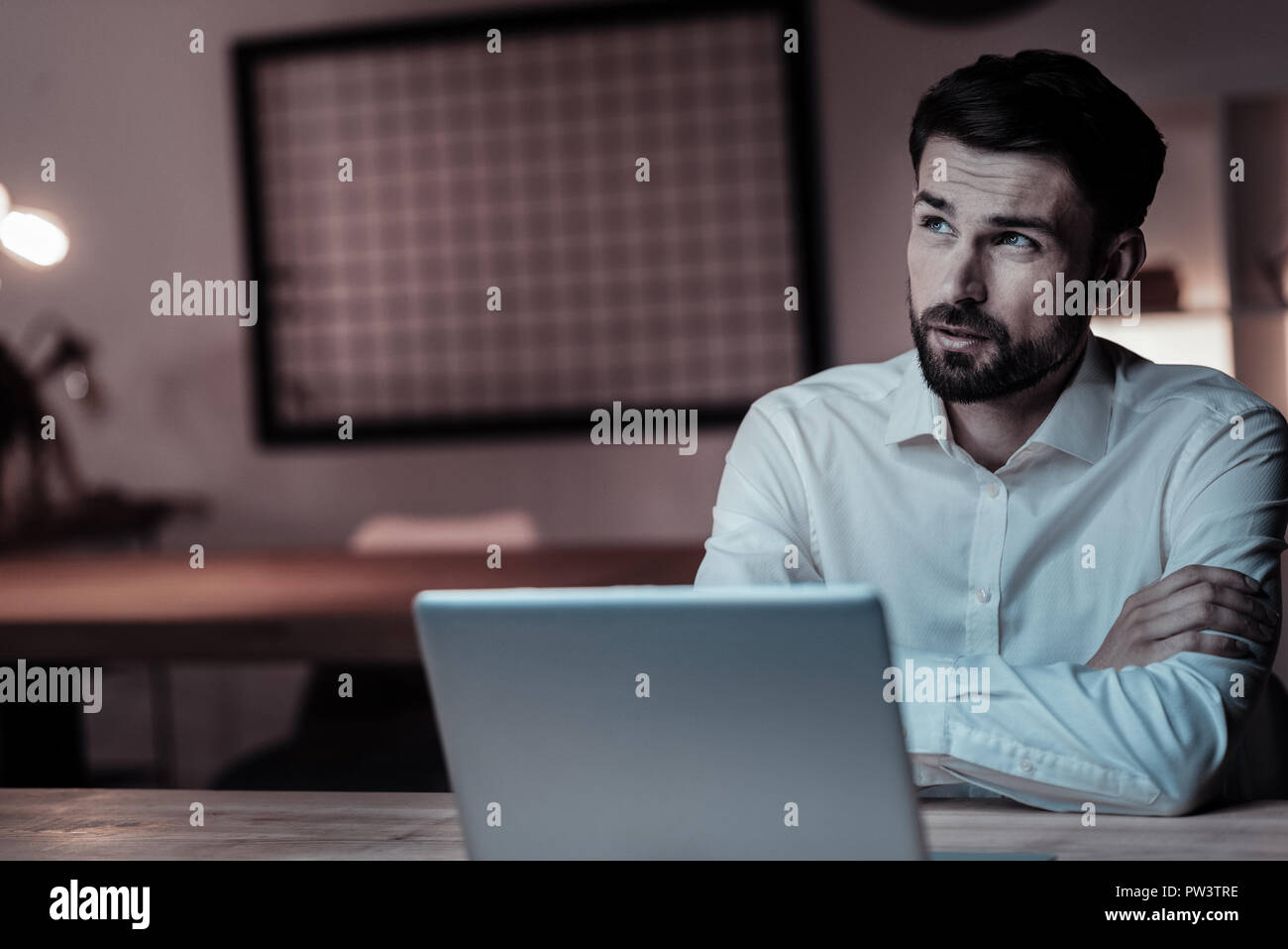 Serious young man looking upwards Stock Photo - Alamy