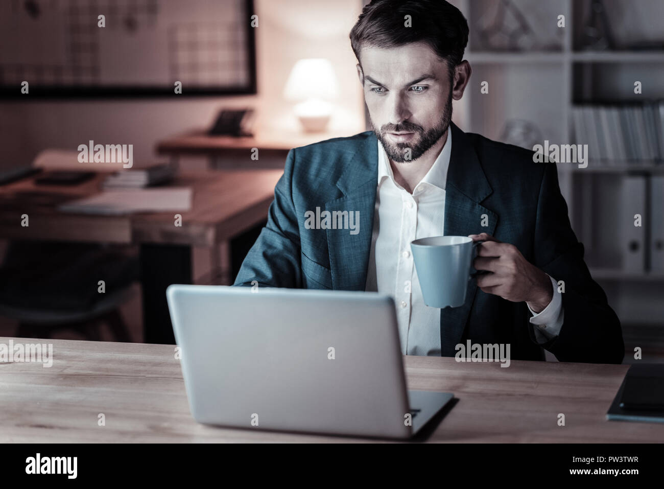 Serious office worker going to drink tea Stock Photo - Alamy