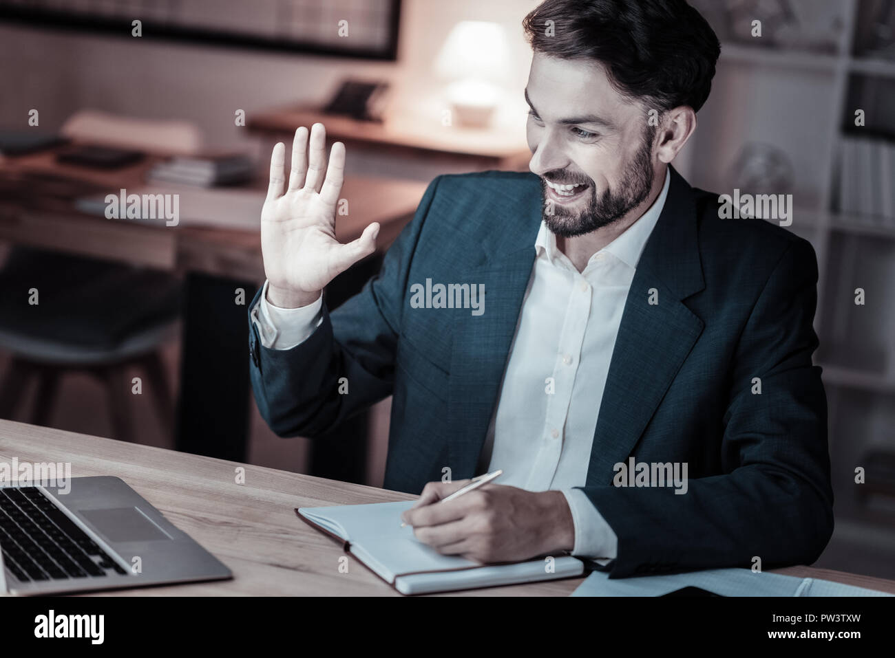Attractive male person waving his hand Stock Photo - Alamy