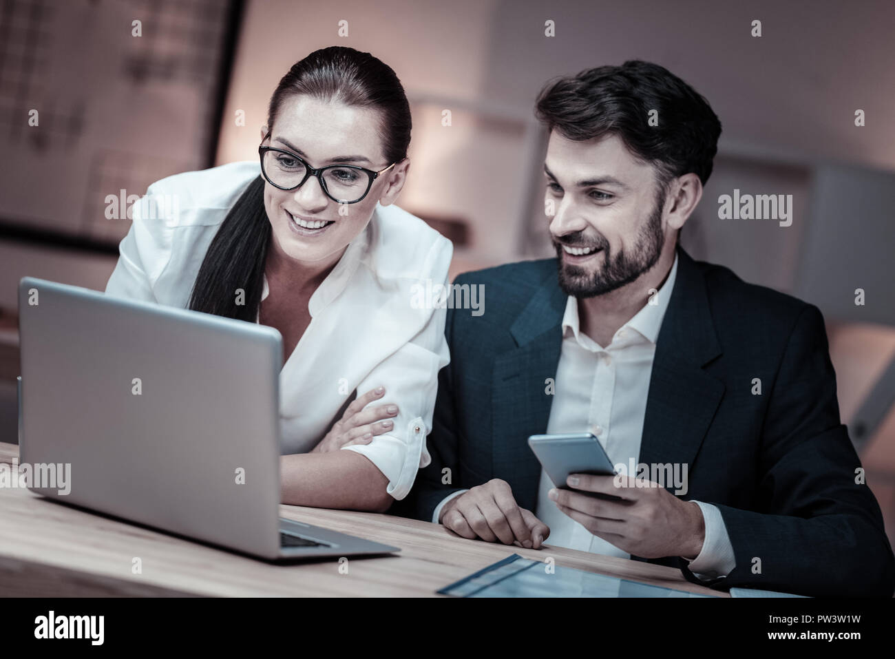 Charming young woman watching presentation Stock Photo - Alamy