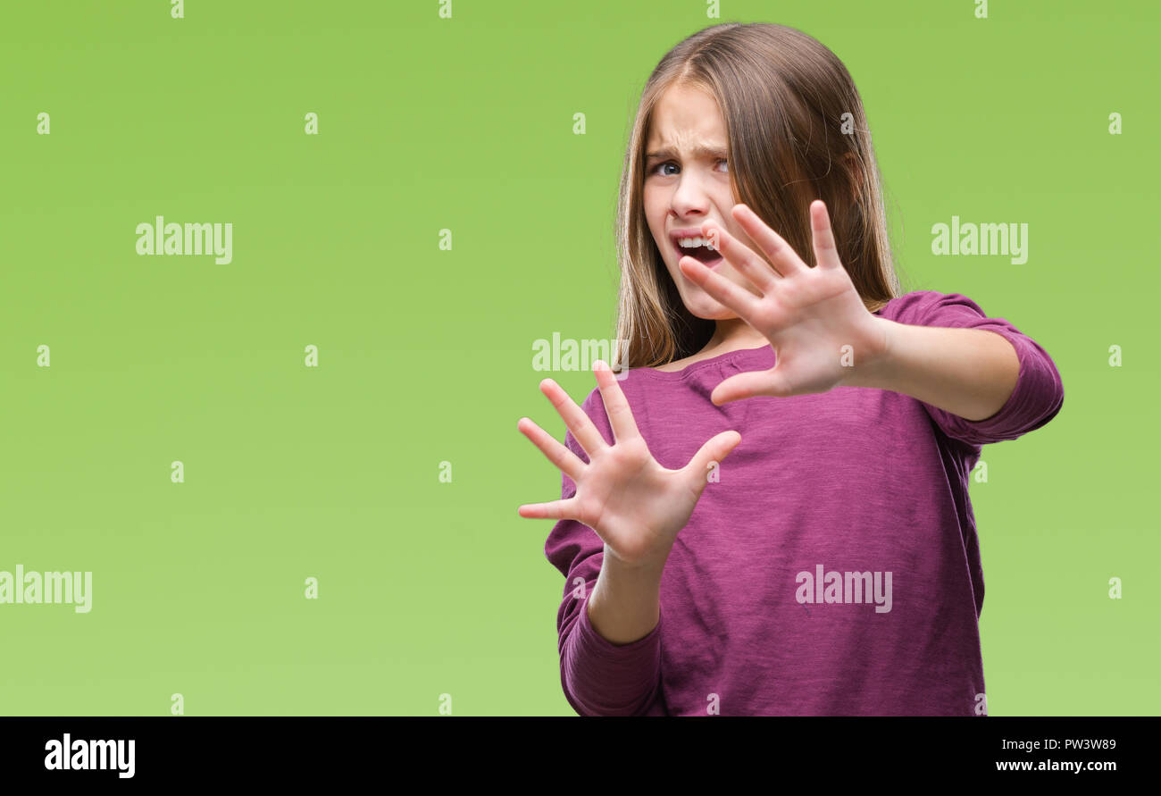 Young beautiful girl over isolated background afraid and terrified with ...