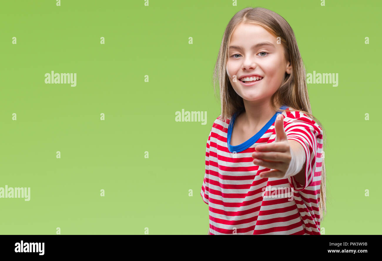 Young beautiful girl over isolated background smiling friendly offering ...