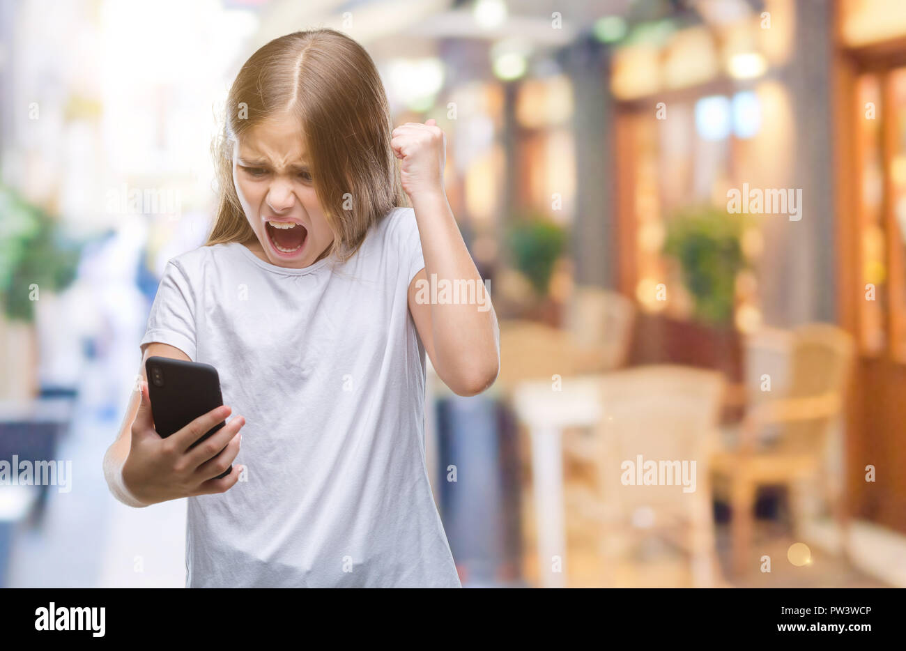 Young beautiful girl sending message texting using smarpthone over ...