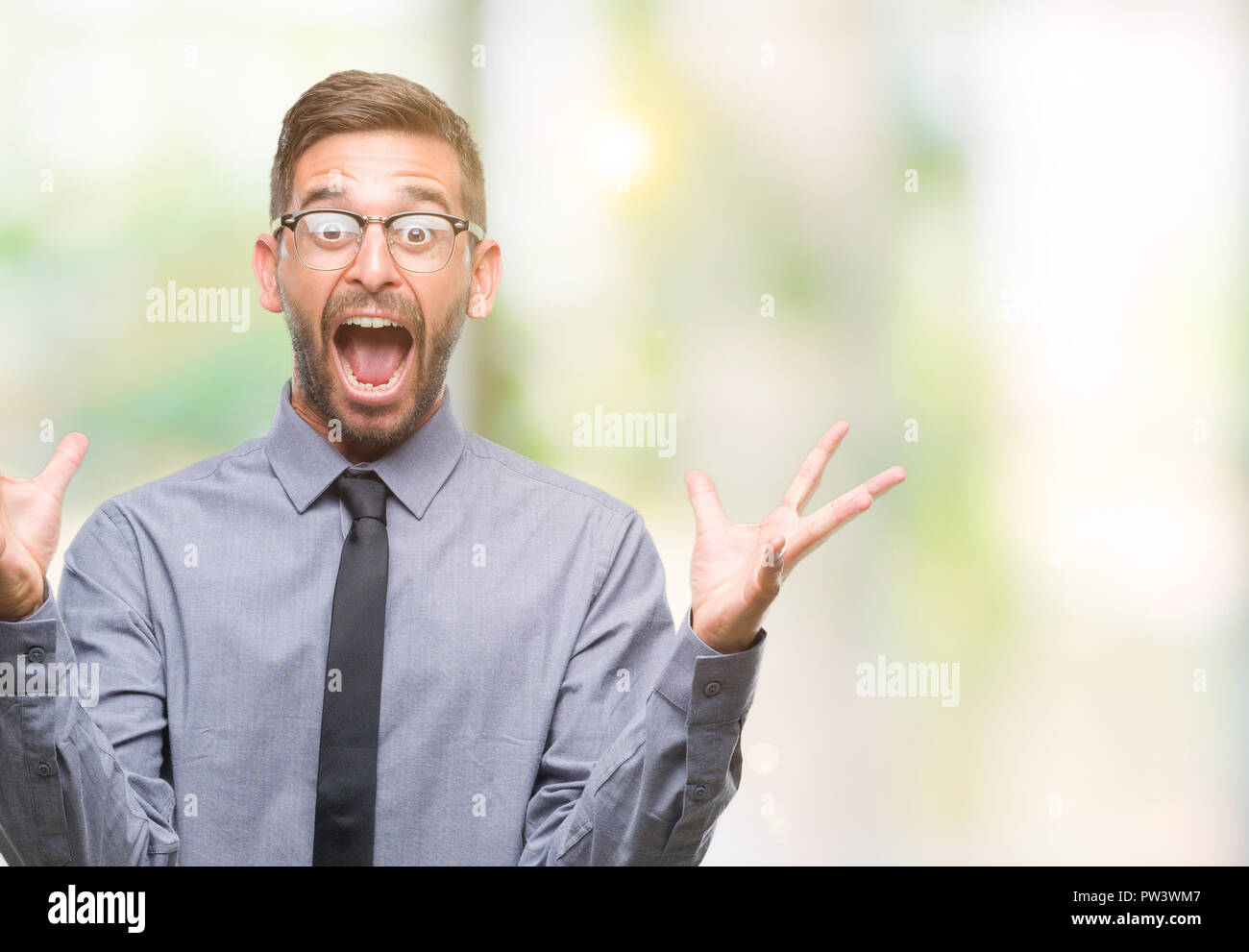 Young handsome business man over isolated background celebrating crazy and amazed for success ...
