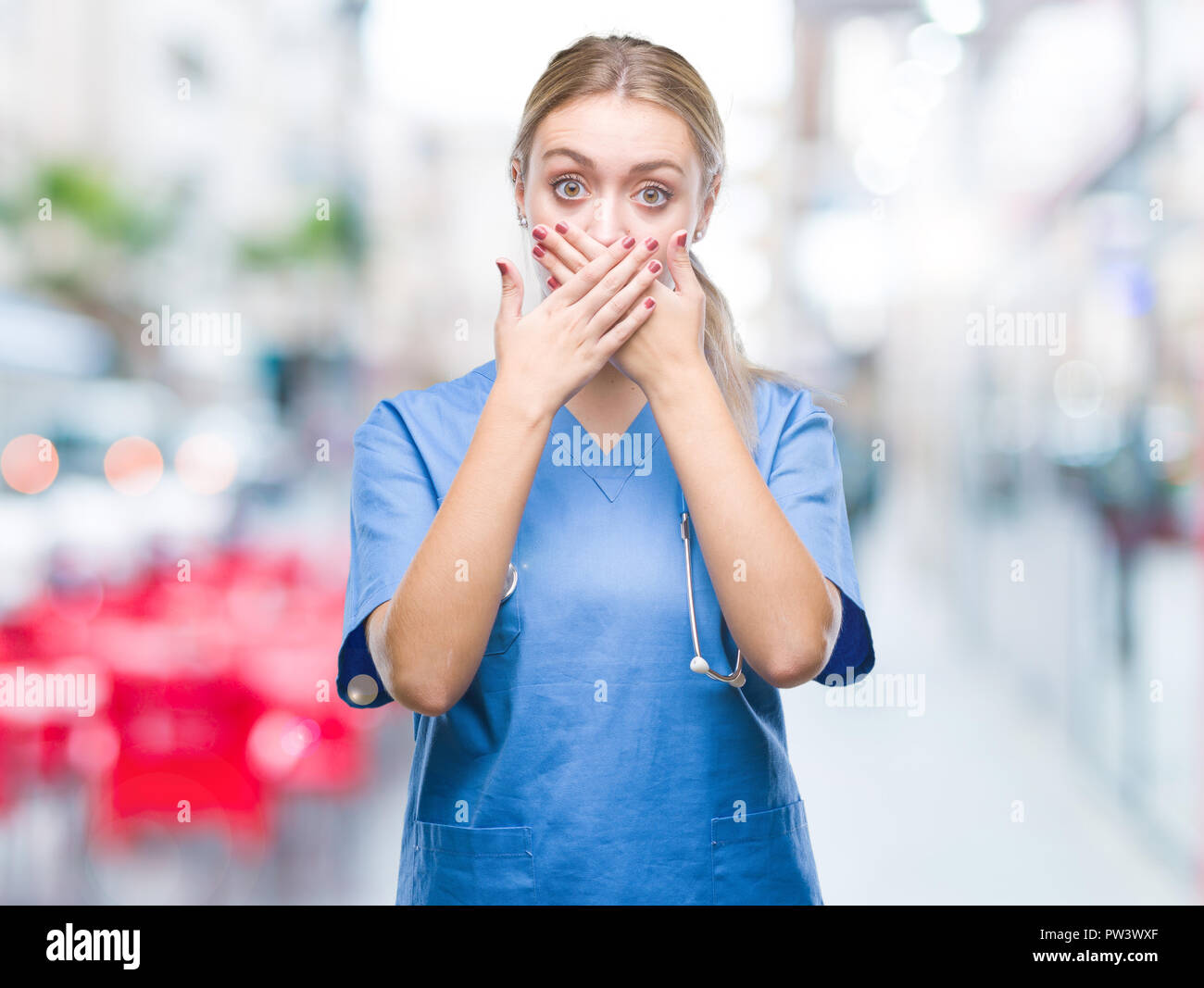 Young blonde surgeon doctor woman over isolated background shocked ...