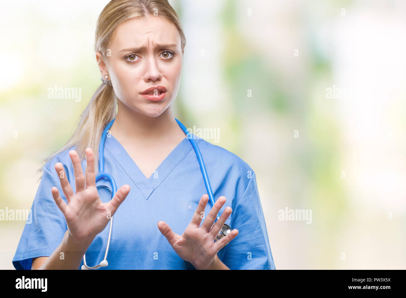 Young blonde surgeon doctor woman over isolated background disgusted ...