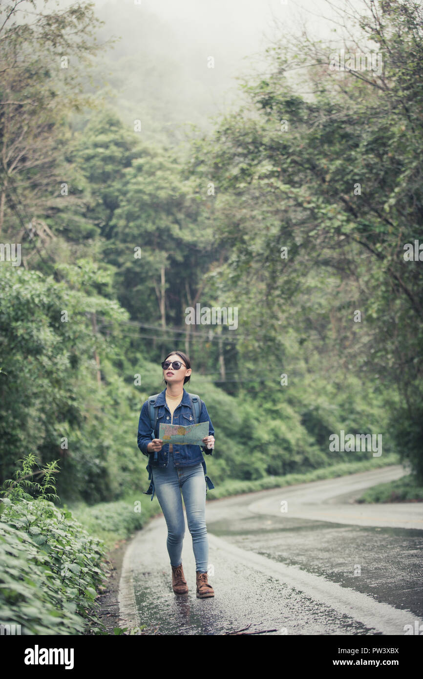 Travelers walking along the road map Stock Photo - Alamy
